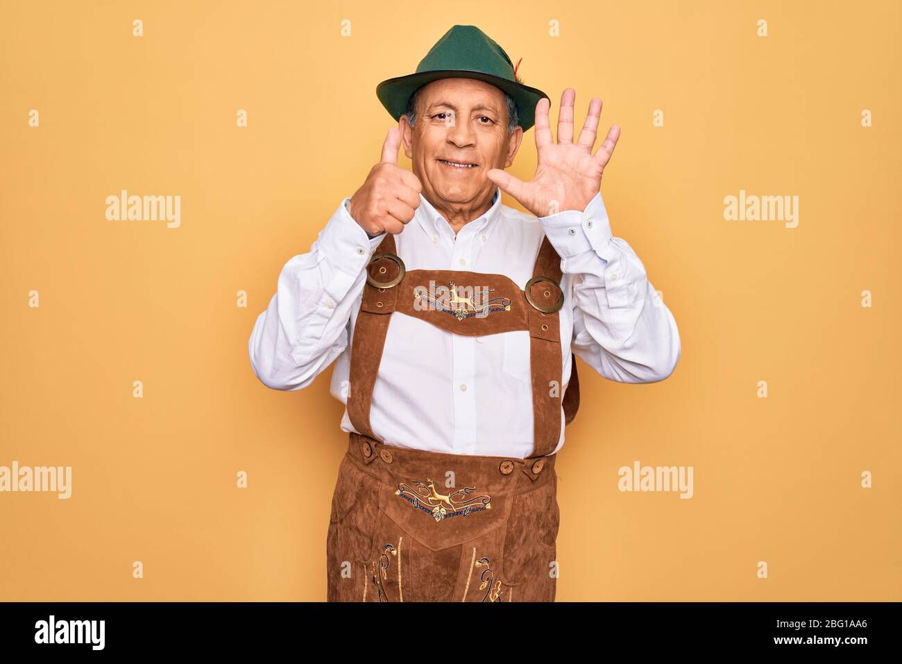 Senior grey-haired man wearing german traditional octoberfest suit over ...