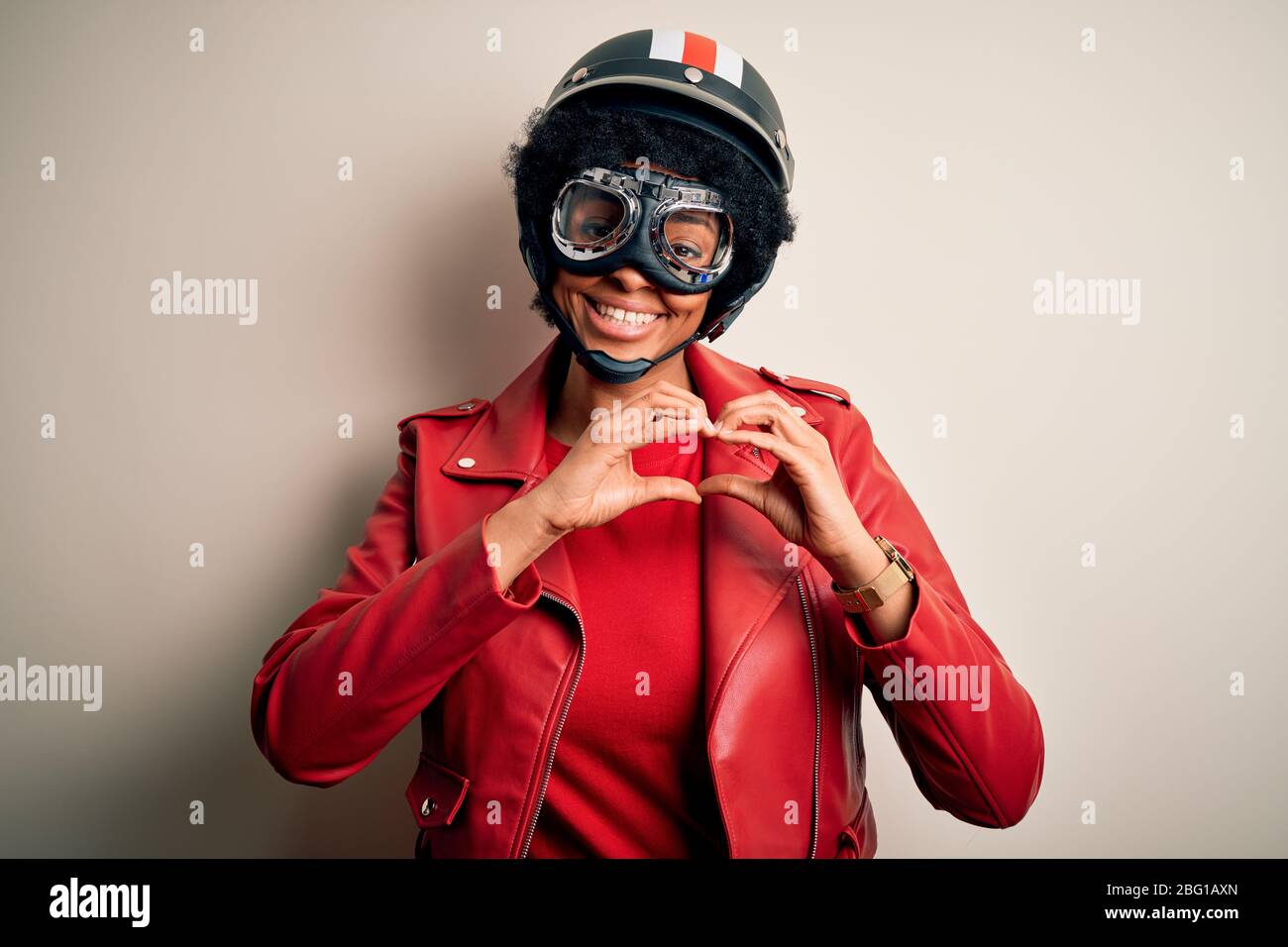 Young African American afro motorcyclist woman with curly hair wearing ...