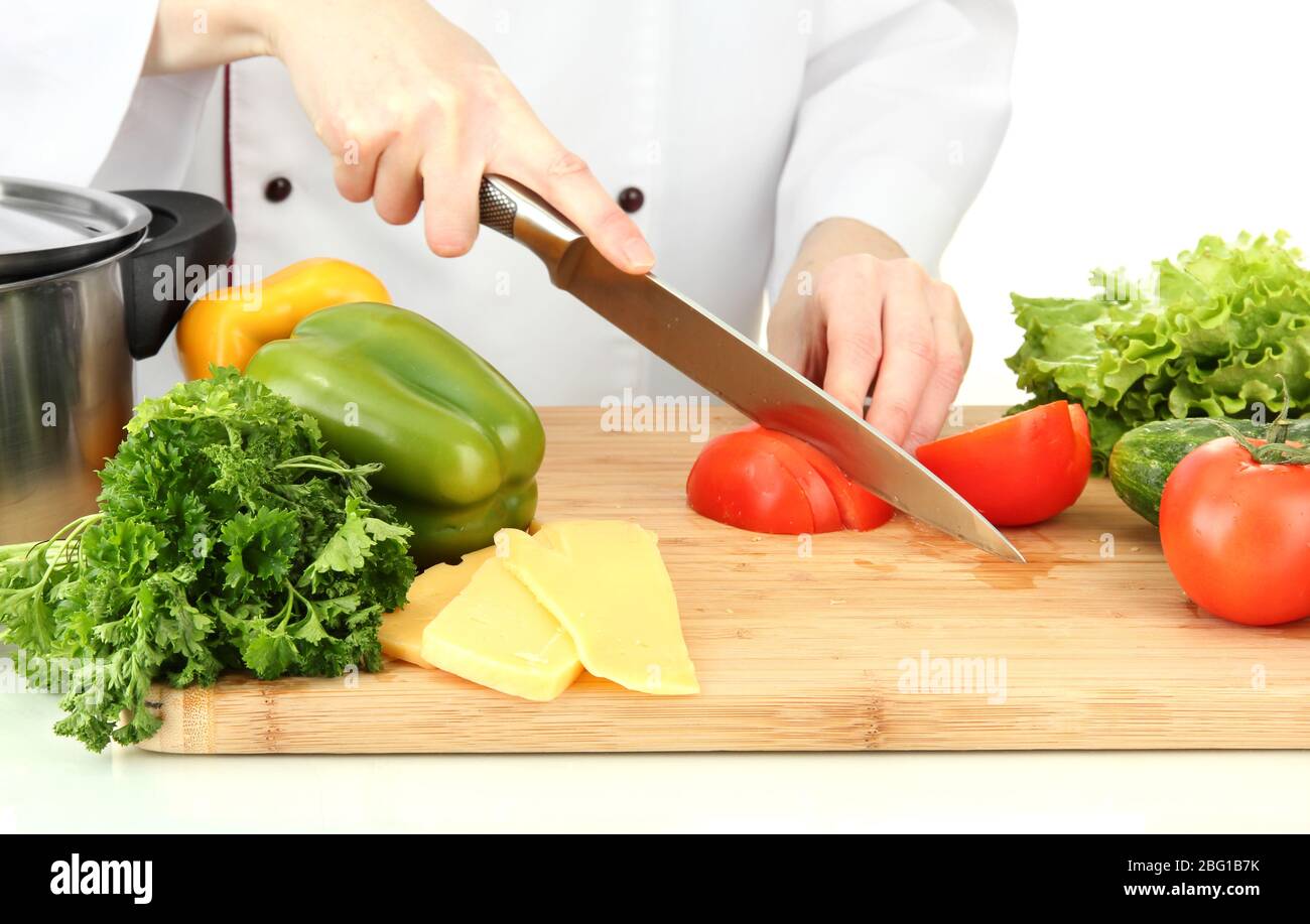 Female hands cutting vegetables, isolated on white Stock Photo - Alamy