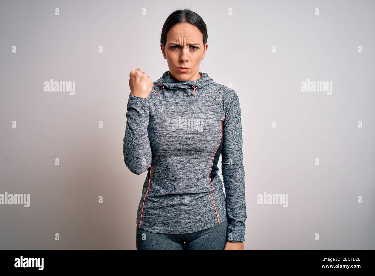 Young blonde fitness woman wearing sport workout clothes over isolated ...