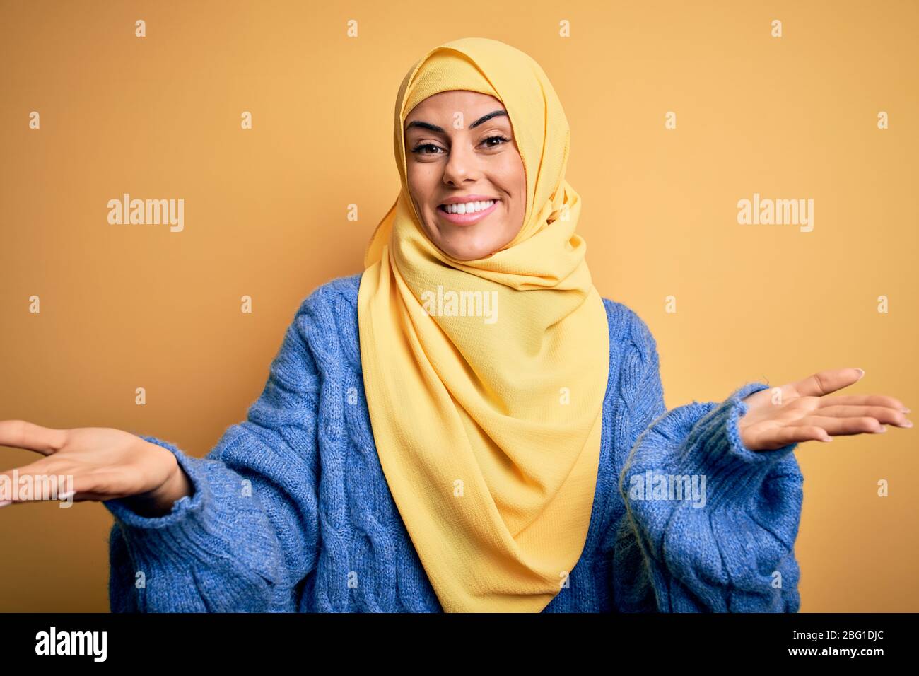 Young beautiful brunette muslim woman wearing arab hijab over isolated ...