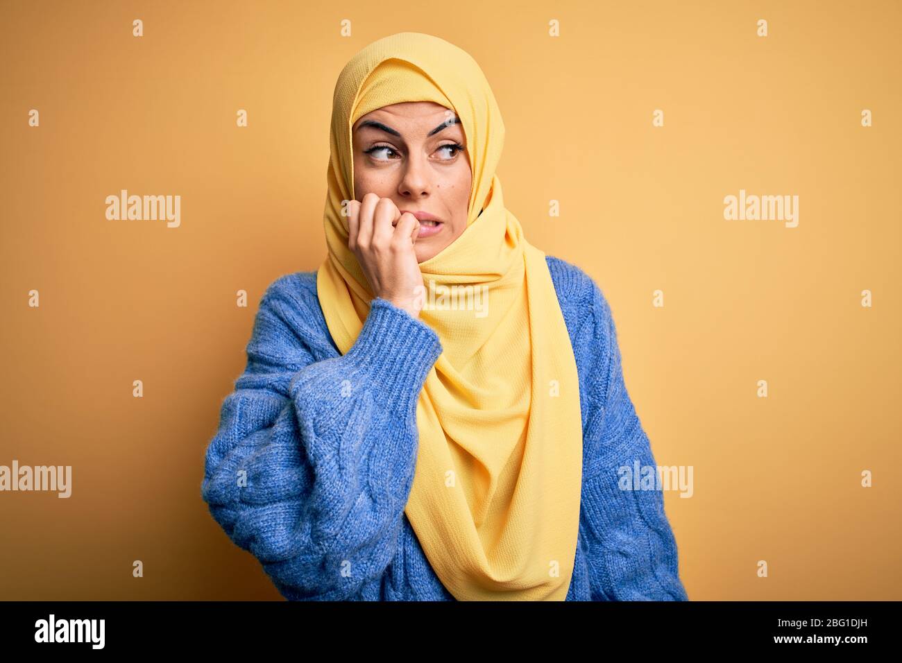 Young beautiful brunette muslim woman wearing arab hijab over isolated ...