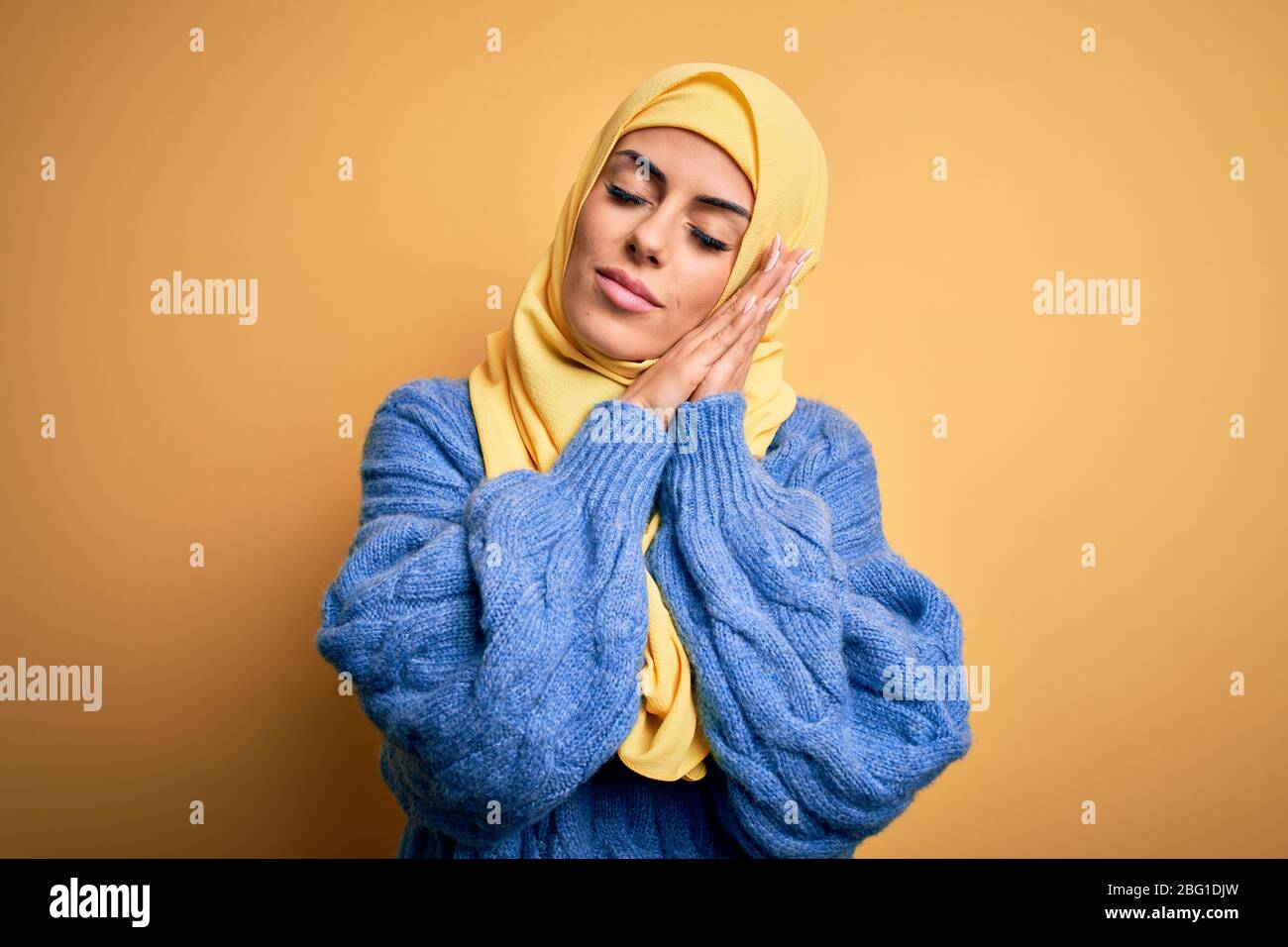 Young beautiful brunette muslim woman wearing arab hijab over isolated ...