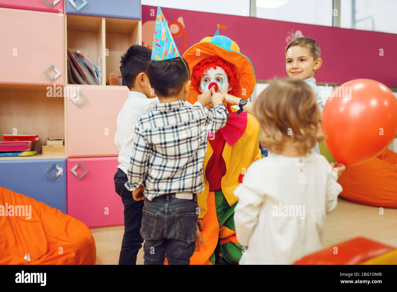 Clown with cheerful children play counting game Stock Photo - Alamy