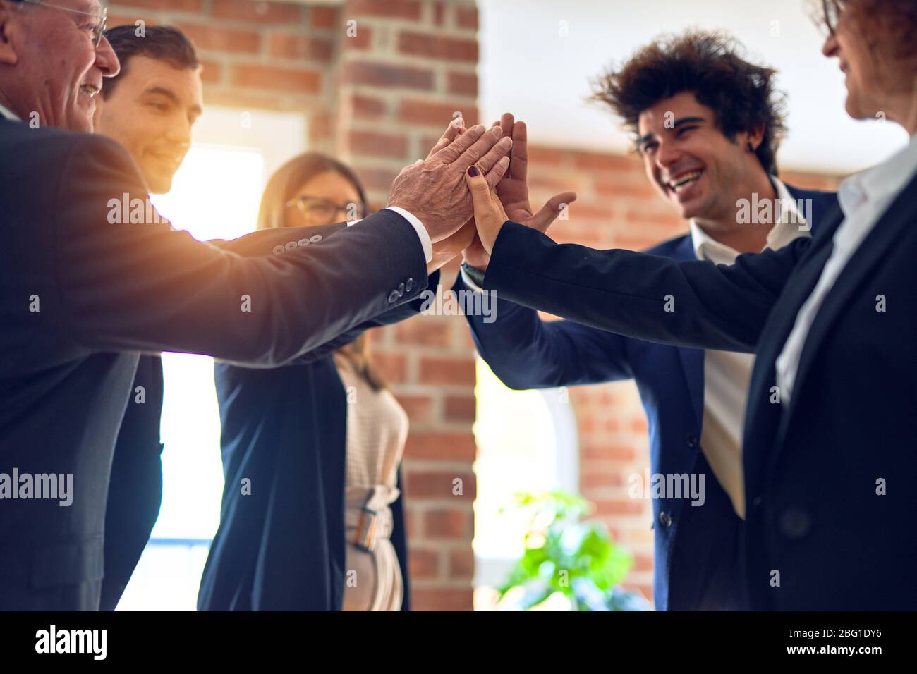 Group of business workers smiling happy and confident. Standing on a ...
