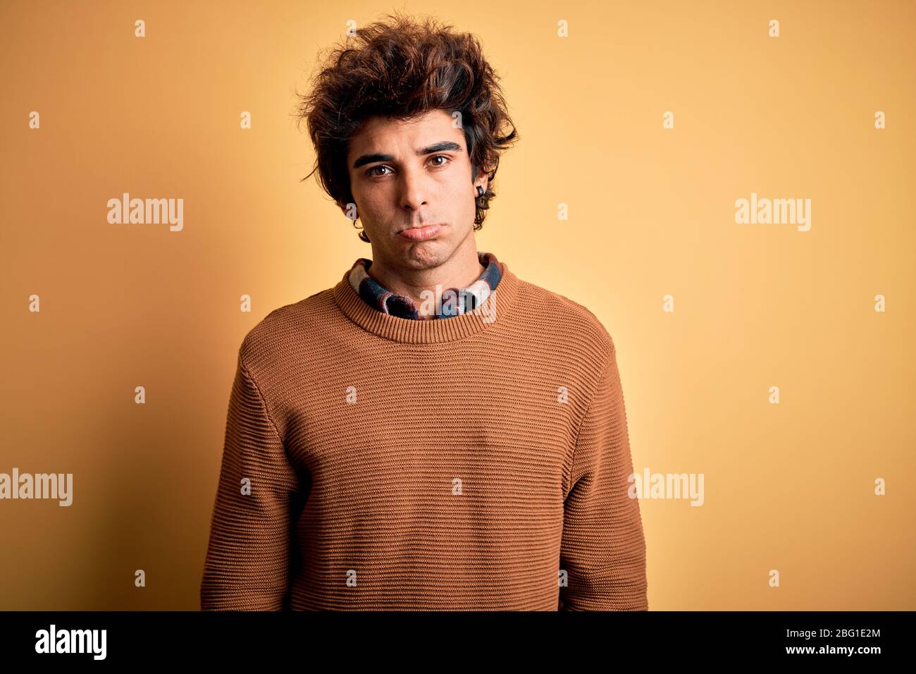 Young handsome man wearing casual shirt and sweater over isolated ...