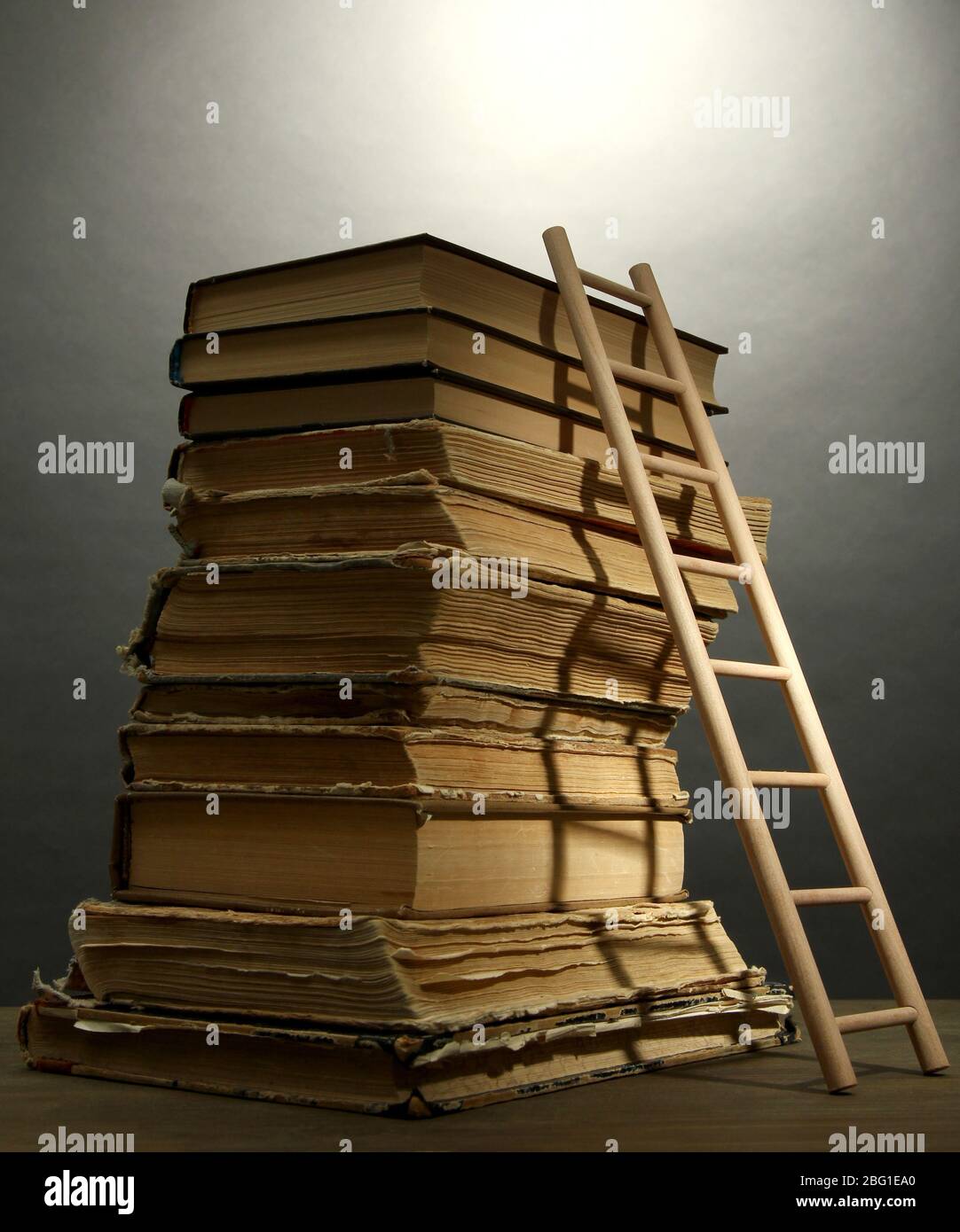 Old books and wooden ladder, on grey background Stock Photo - Alamy