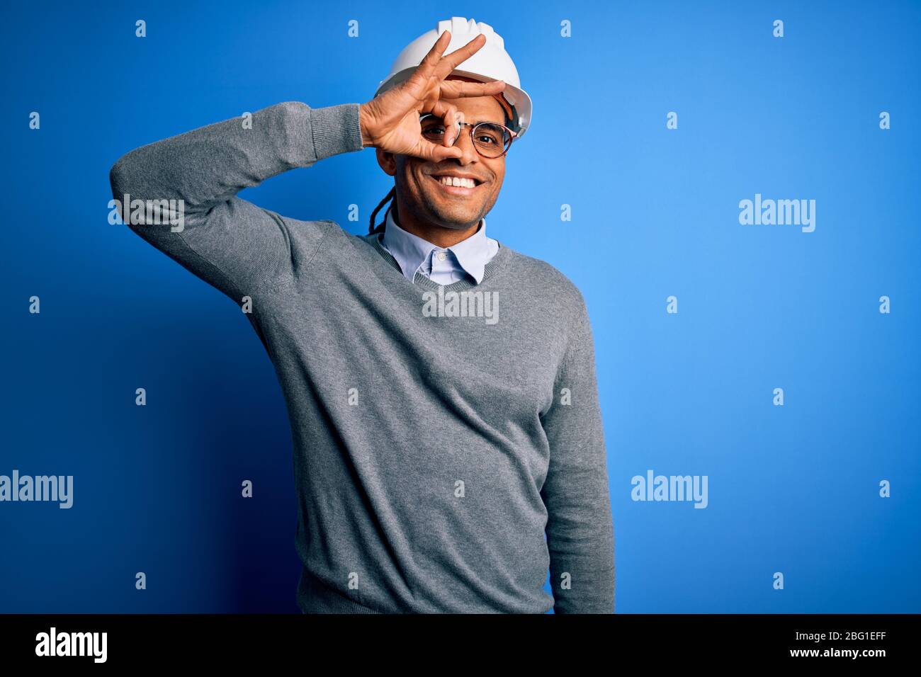 Young handsome african american engineer man with dreadlocks wearing ...