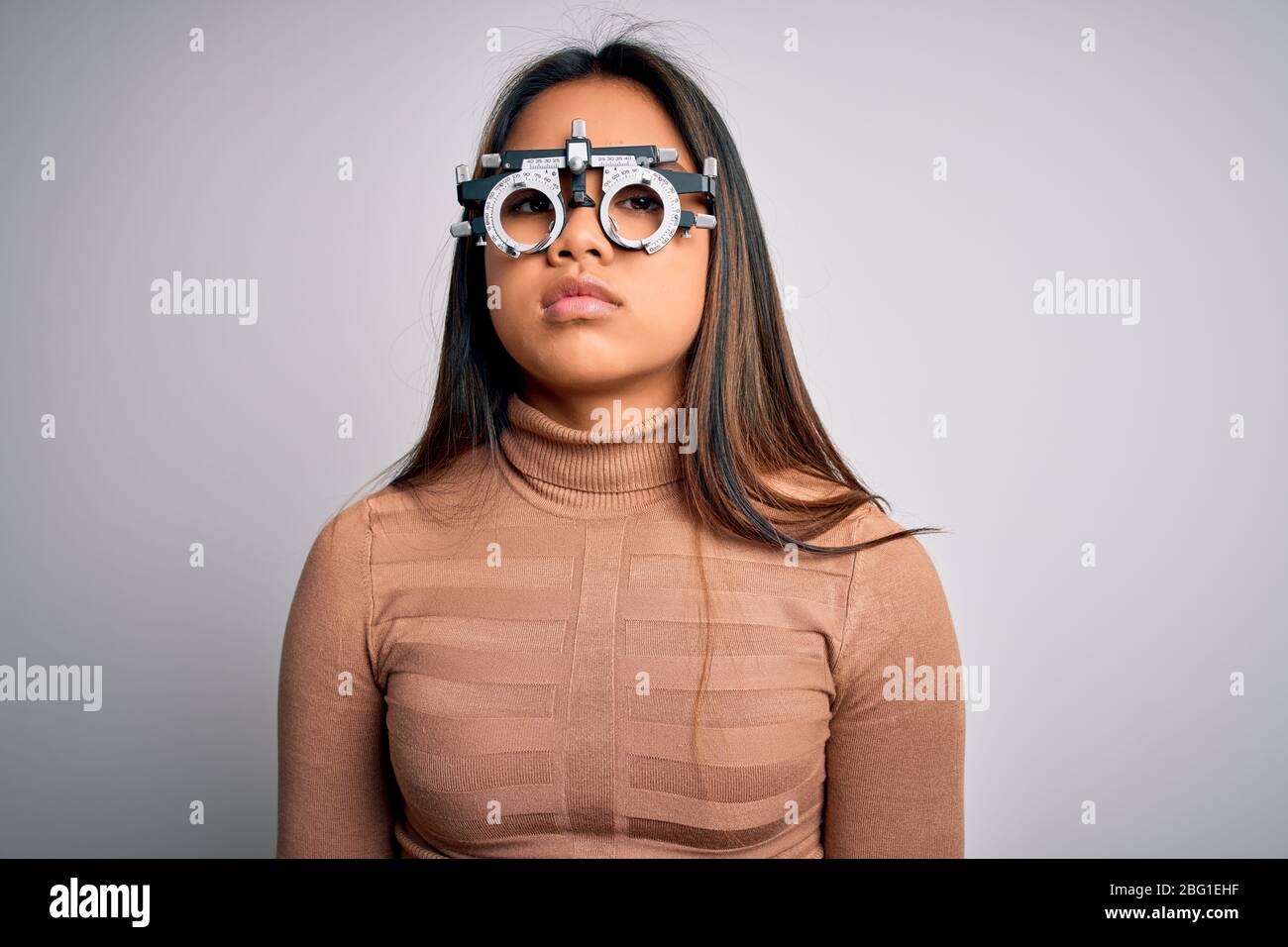 Young asian optical girl controlling eyesight using optometry glasses ...