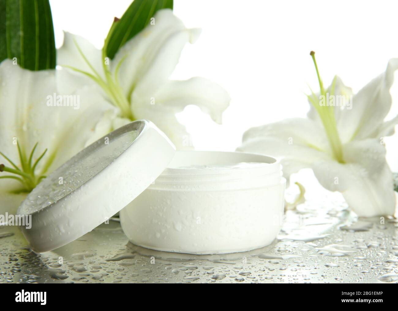 Cosmetic cream and beautiful lily, close up Stock Photo - Alamy