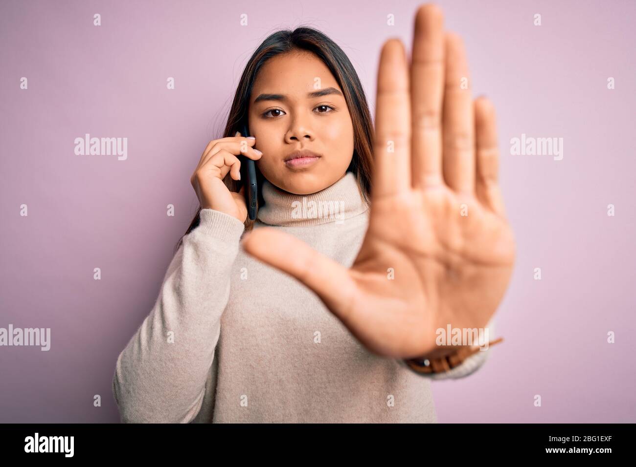 Young asian girl having conversation talking on the smartphone over ...