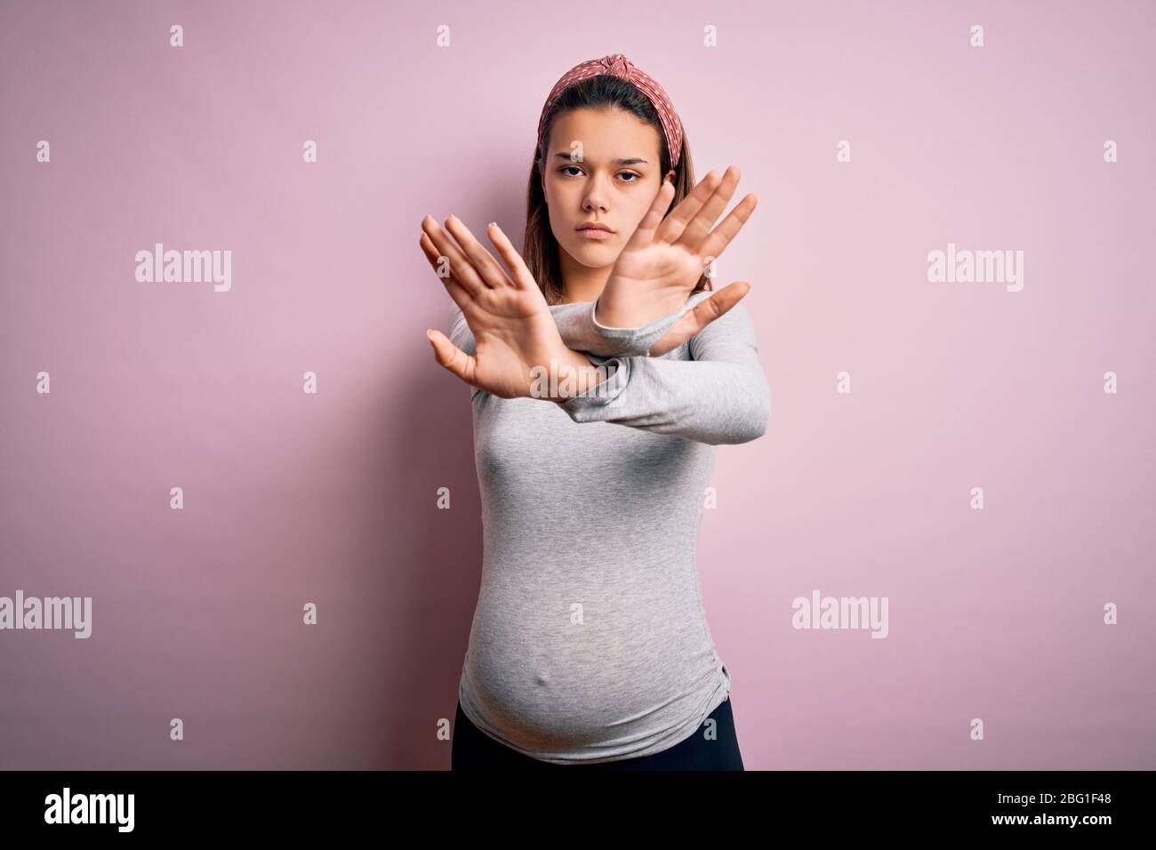 Young beautiful teenager girl pregnant expecting baby over isolated ...