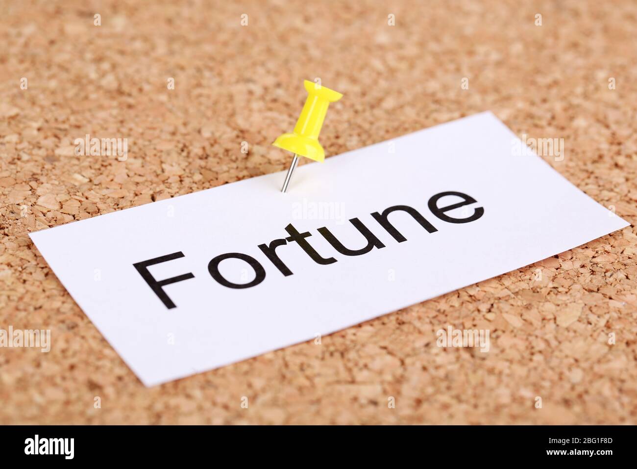 Push pin on paper with word fortune on cork board Stock Photo - Alamy