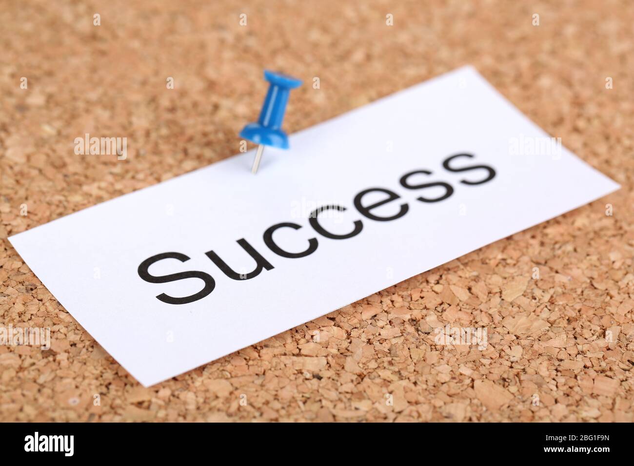 Push pin on paper with word success on cork board Stock Photo - Alamy