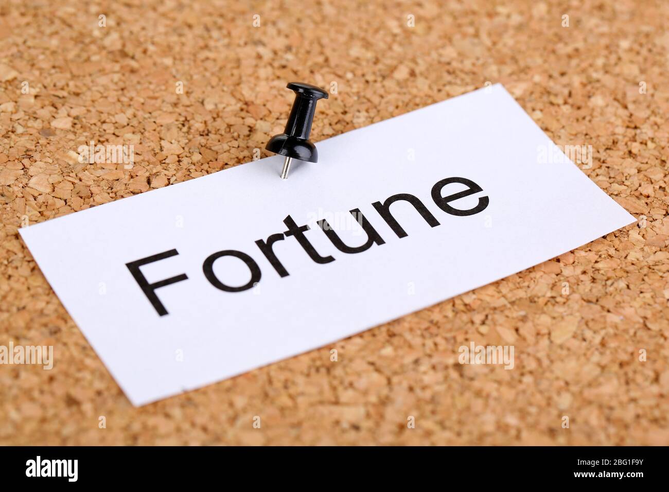 Push pin on paper with word fortune on cork board Stock Photo - Alamy