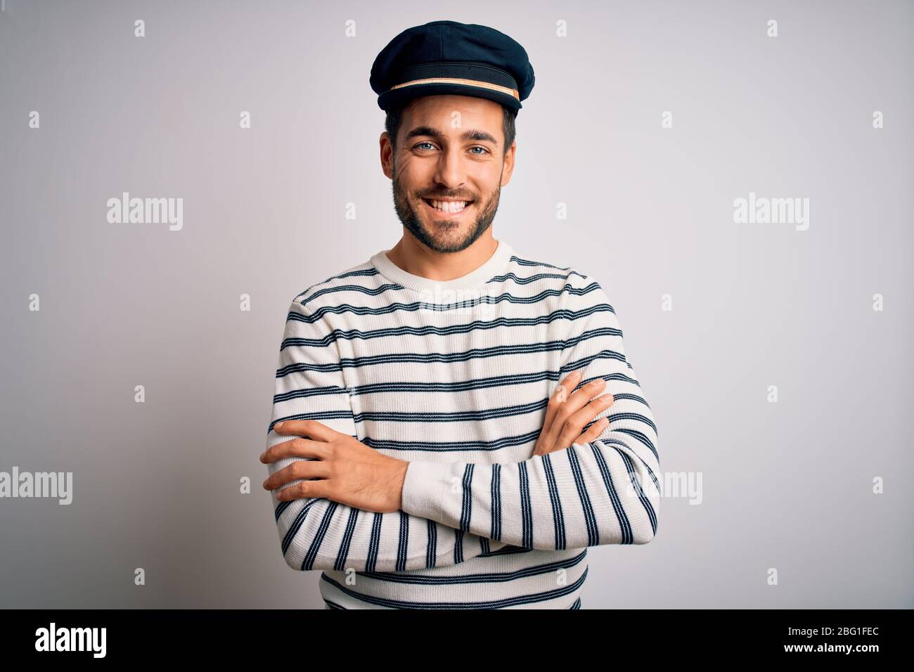 Young handsome sailor man with beard wearing navy striped uniform and ...