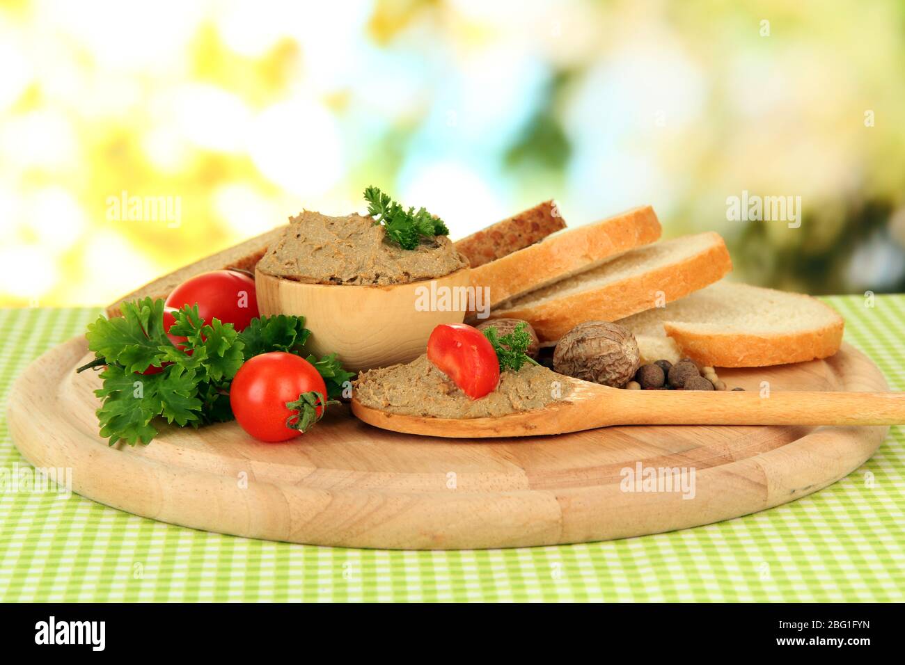 Composition of fresh pate, tomatoes and bread, on bright background ...