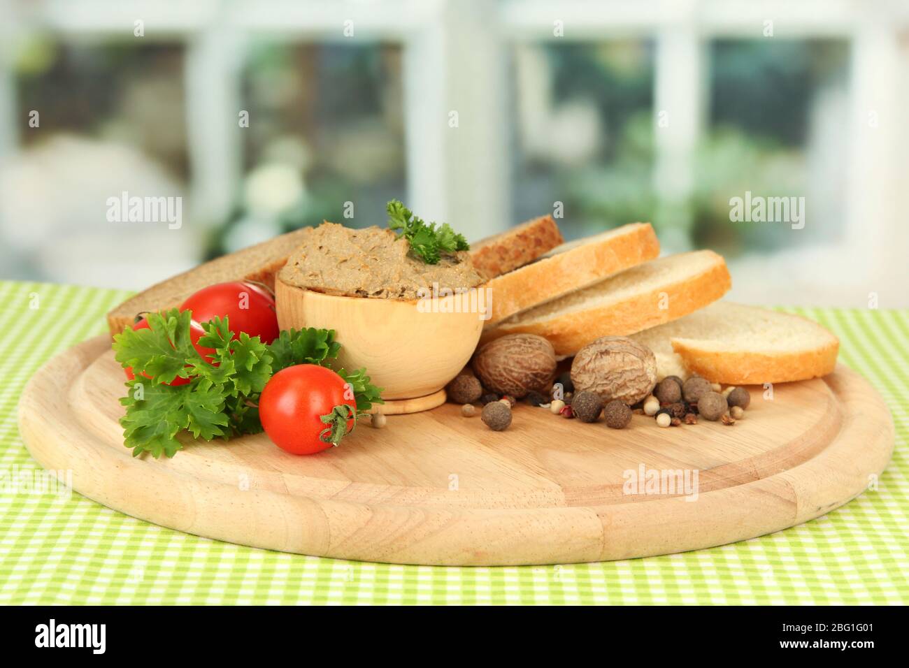 Composition of fresh pate, tomatoes and bread, on bright background ...