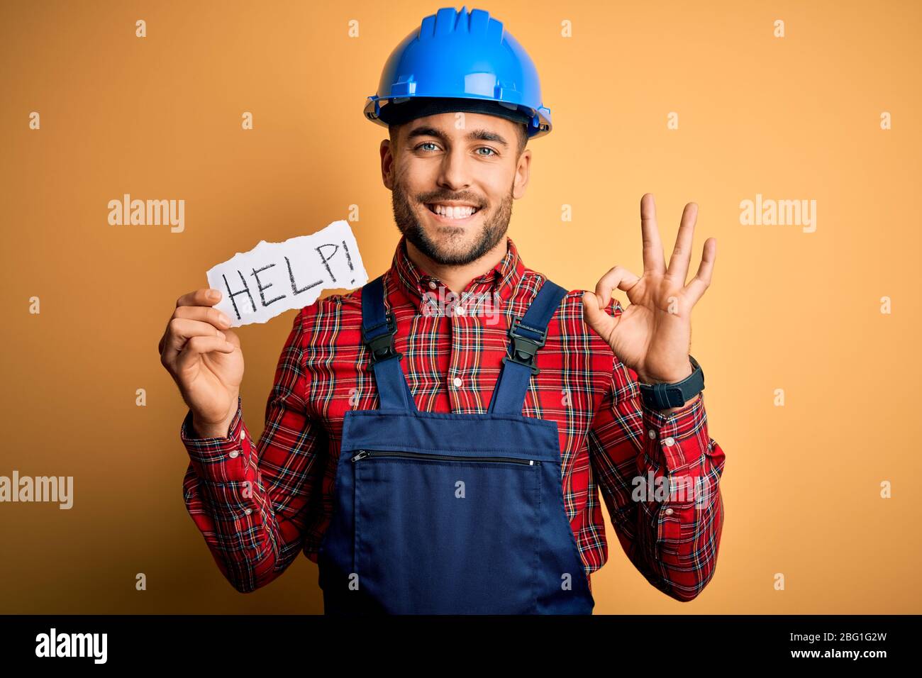 Young builder man wearing safety helmet offering help and support over ...