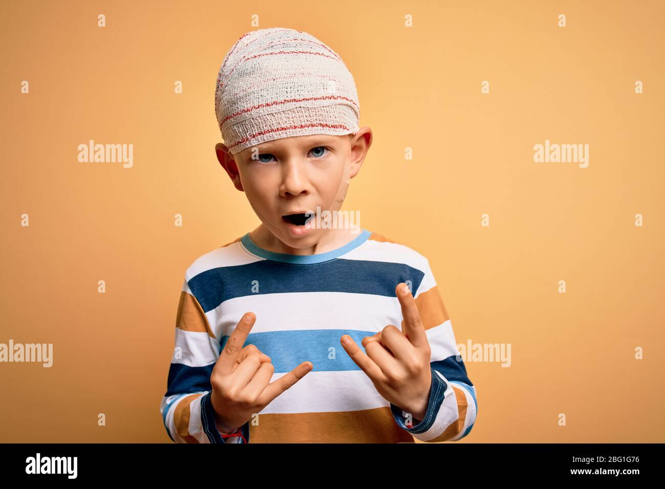 Young little caucasian kid injured wearing medical bandage on head over ...