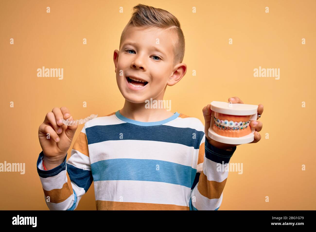 Little kid boy holding professional orthodontic denture with metal ...