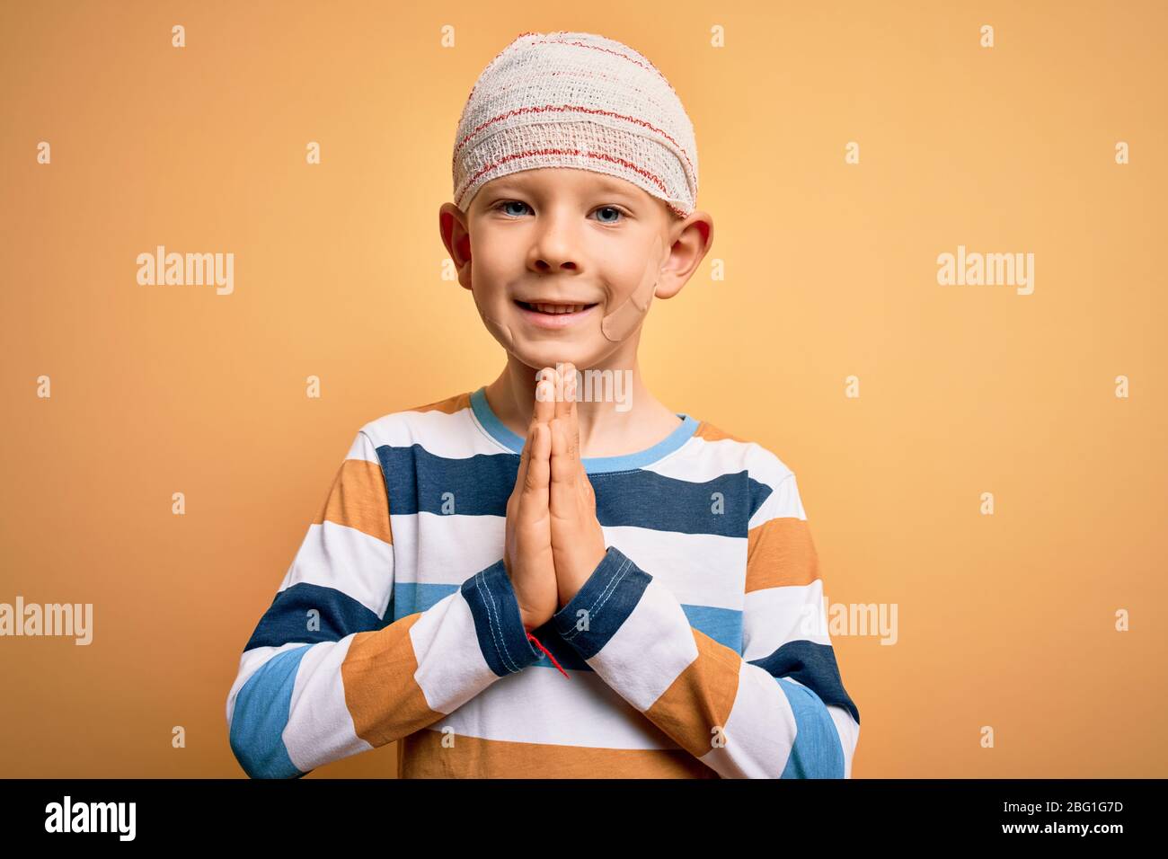 Young little caucasian kid injured wearing medical bandage on head over ...