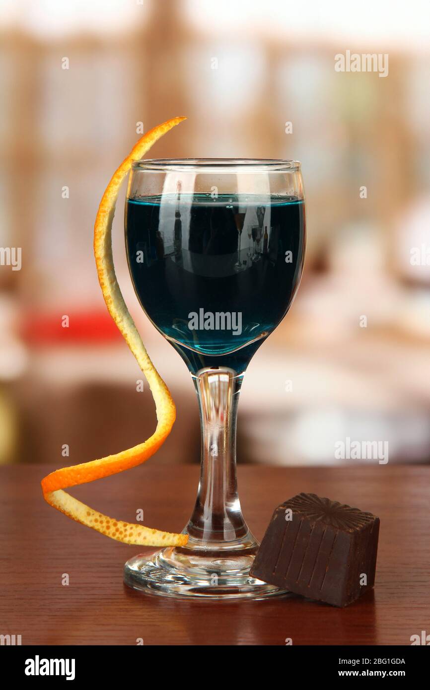 Tasty color liquor, on bright background Stock Photo - Alamy