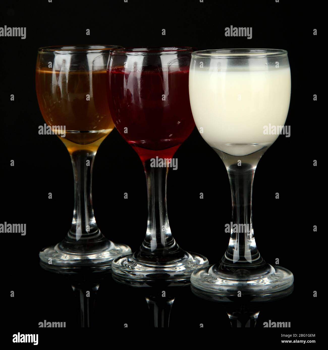 Tasty color liquors, isolated on black Stock Photo - Alamy