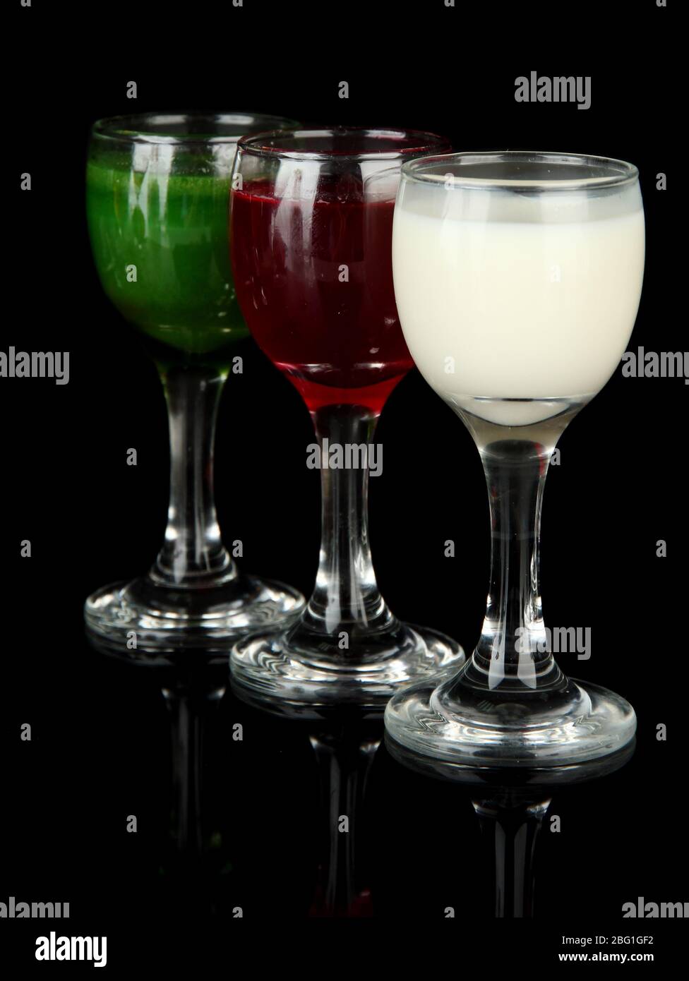Tasty color liquors, isolated on black Stock Photo - Alamy