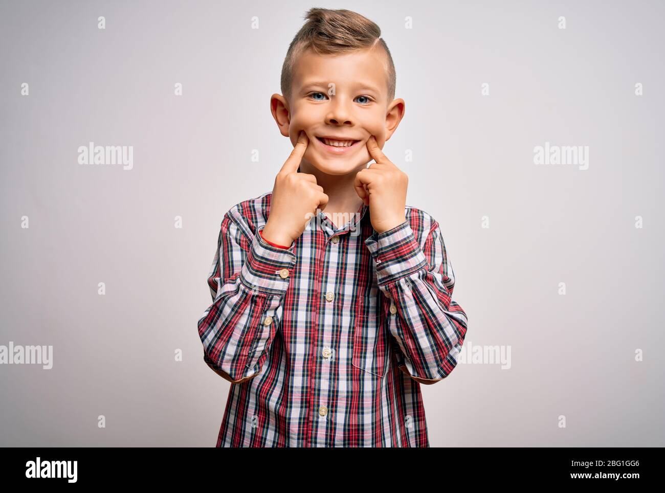 Young little caucasian kid with blue eyes wearing elegant shirt ...