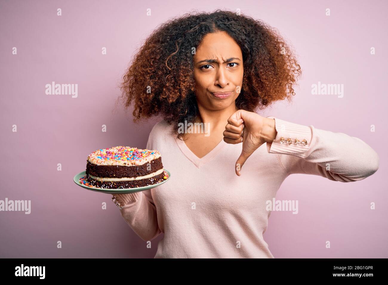 Young african american woman with afro hair holding delicious birthday ...