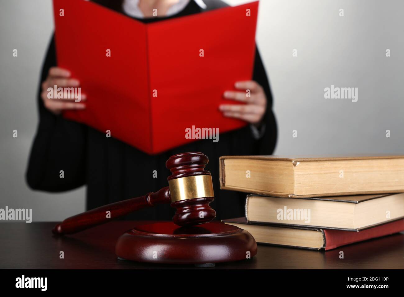 Judge read verdict on grey background Stock Photo - Alamy