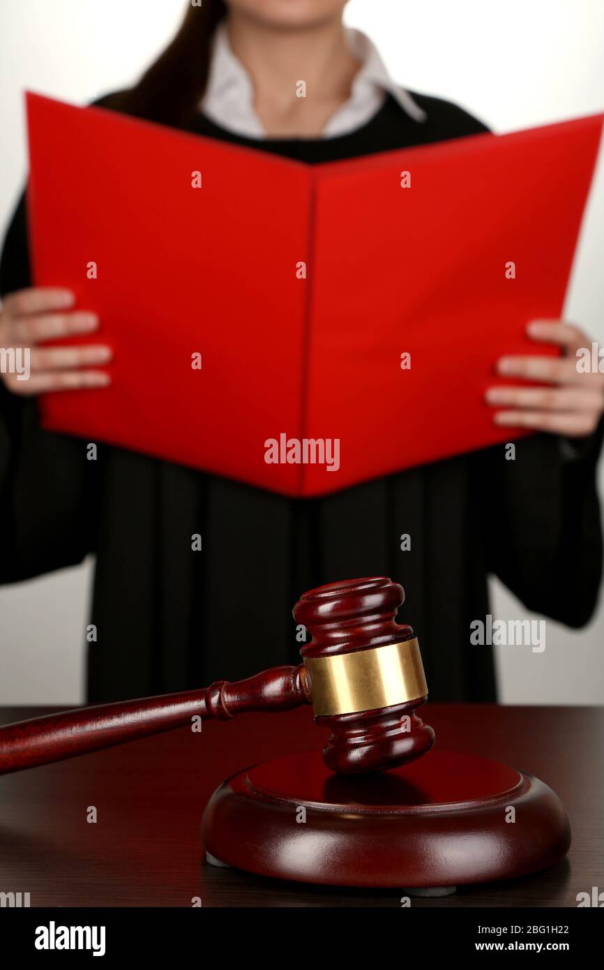 Judge read verdict on grey background Stock Photo - Alamy