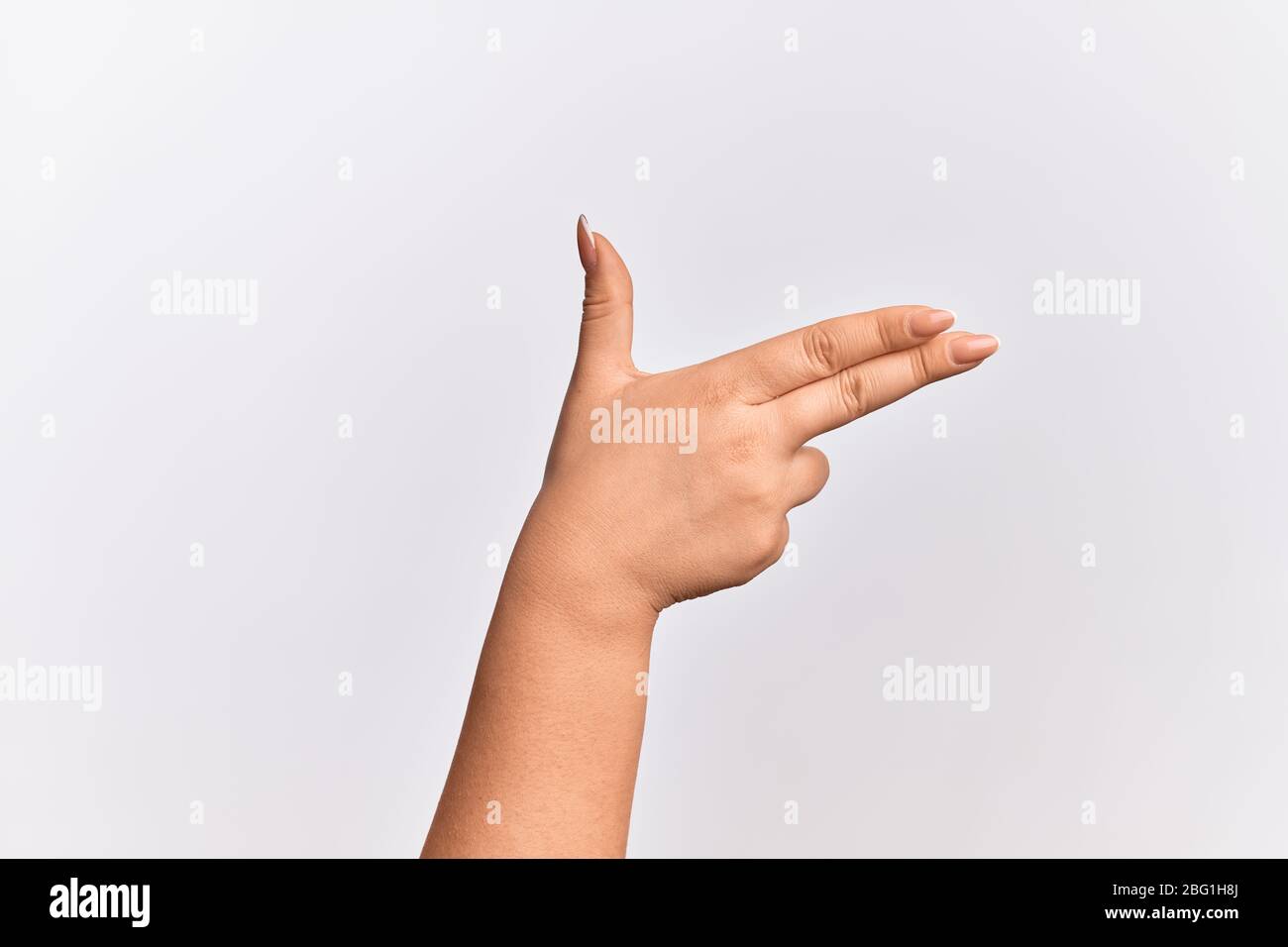 Hand of caucasian young woman gesturing fire gun weapon with fingers ...