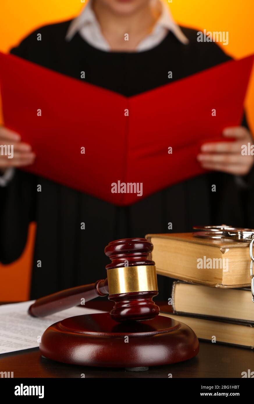 Judge read verdict on orange background Stock Photo - Alamy