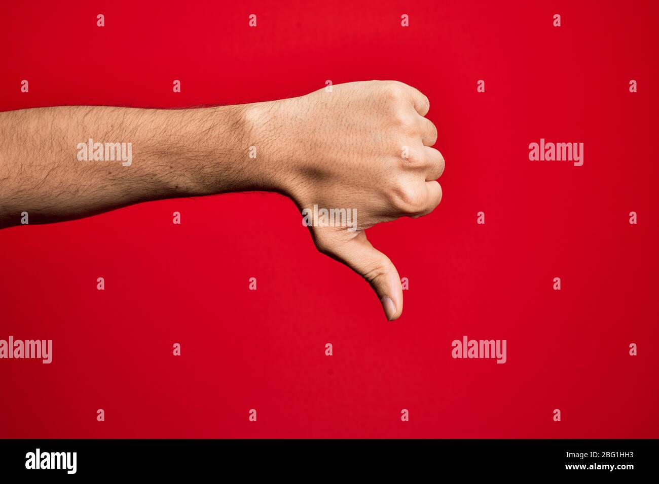 Hand of caucasian young man showing fingers over isolated red ...