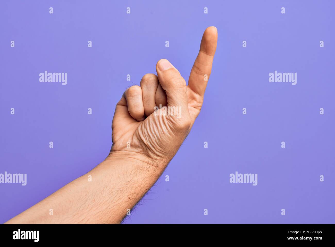 Hand of caucasian young man showing fingers over isolated purple ...
