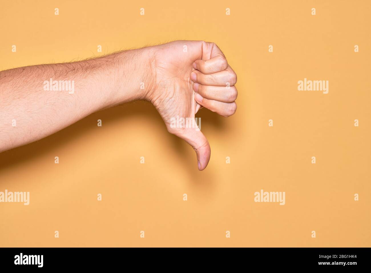 Hand of caucasian young man showing fingers over isolated yellow ...