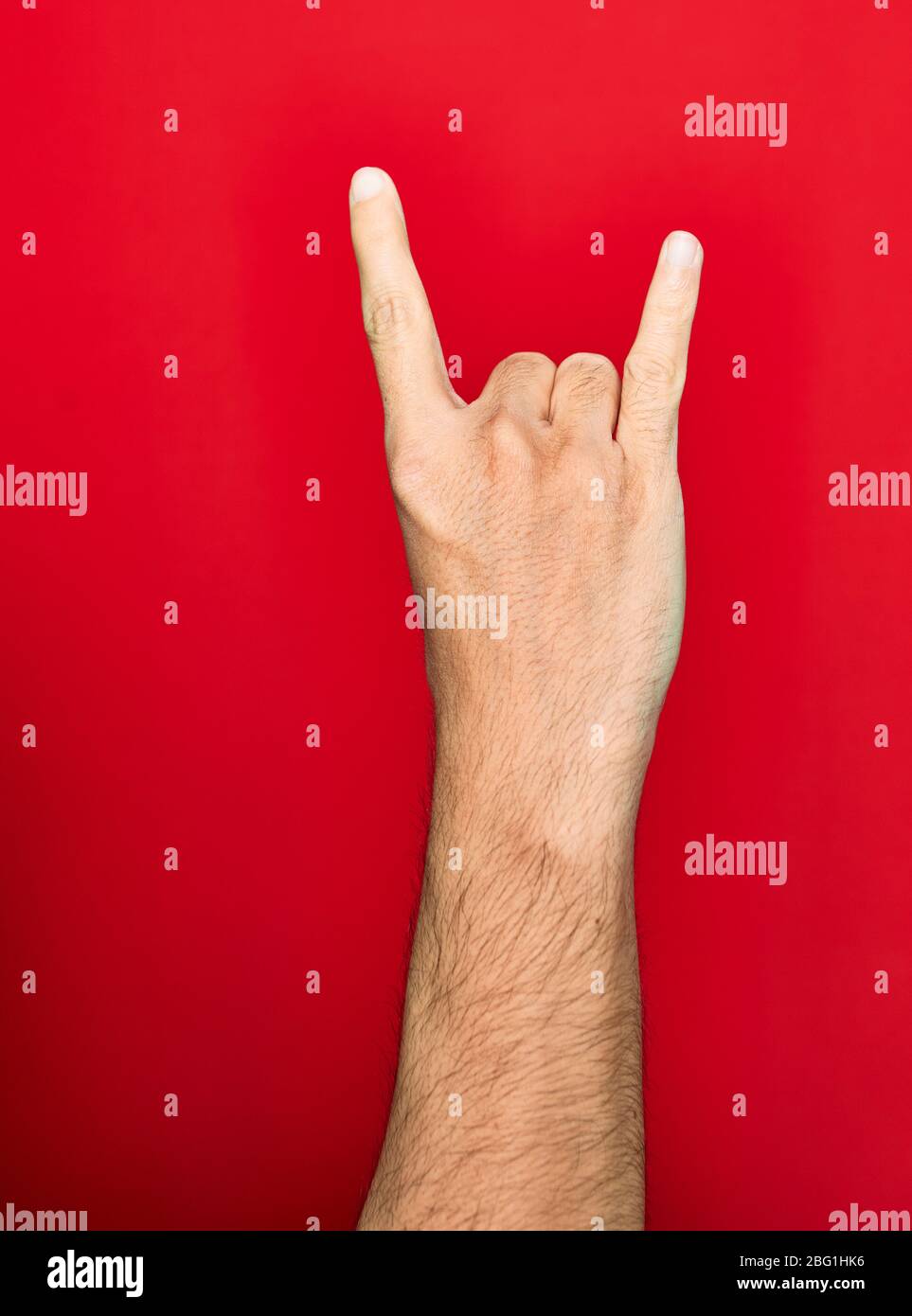Beautiful hand of man doing rock symbol with horns sign Stock Photo - Alamy