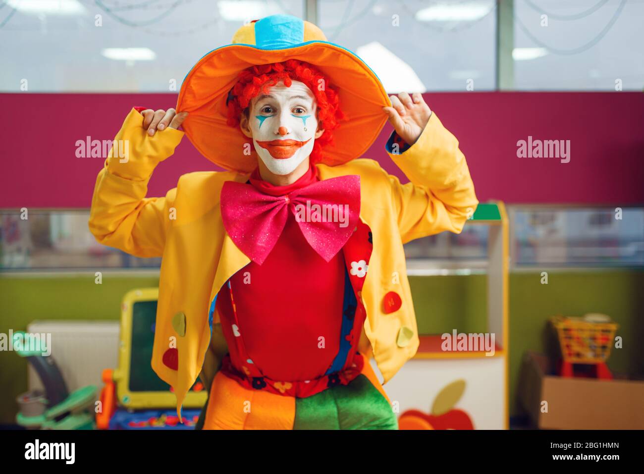 Funny clown dressed in colorful hat and costume Stock Photo - Alamy