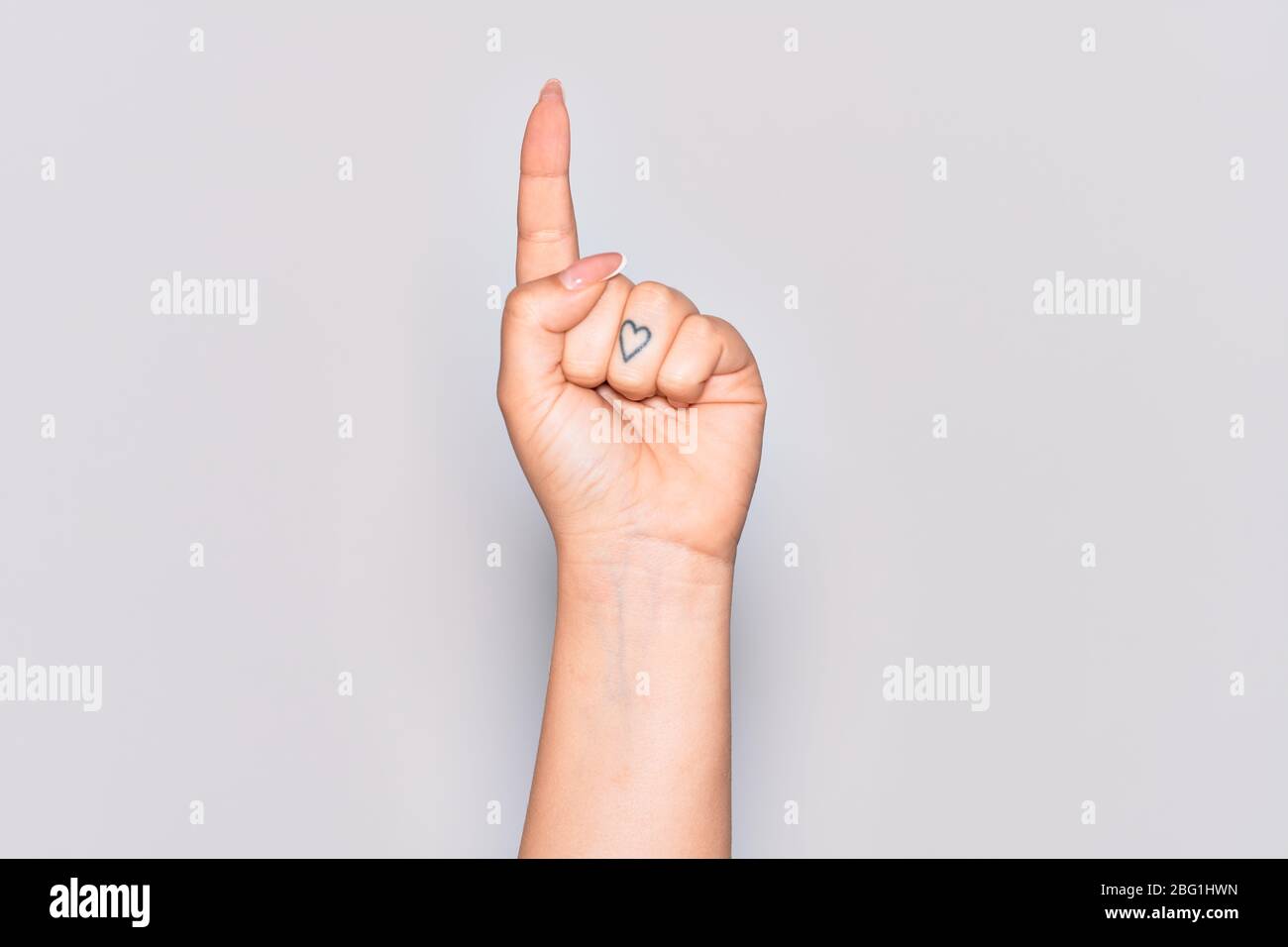 Hand of caucasian young woman counting number one using index finger ...