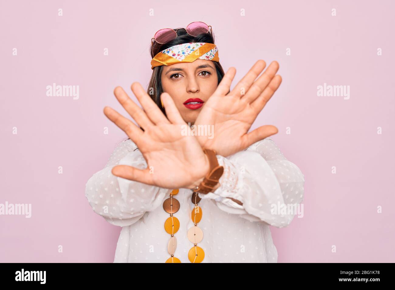 Young hispanic hippie woman wearing fashion boho style and sunglasses ...