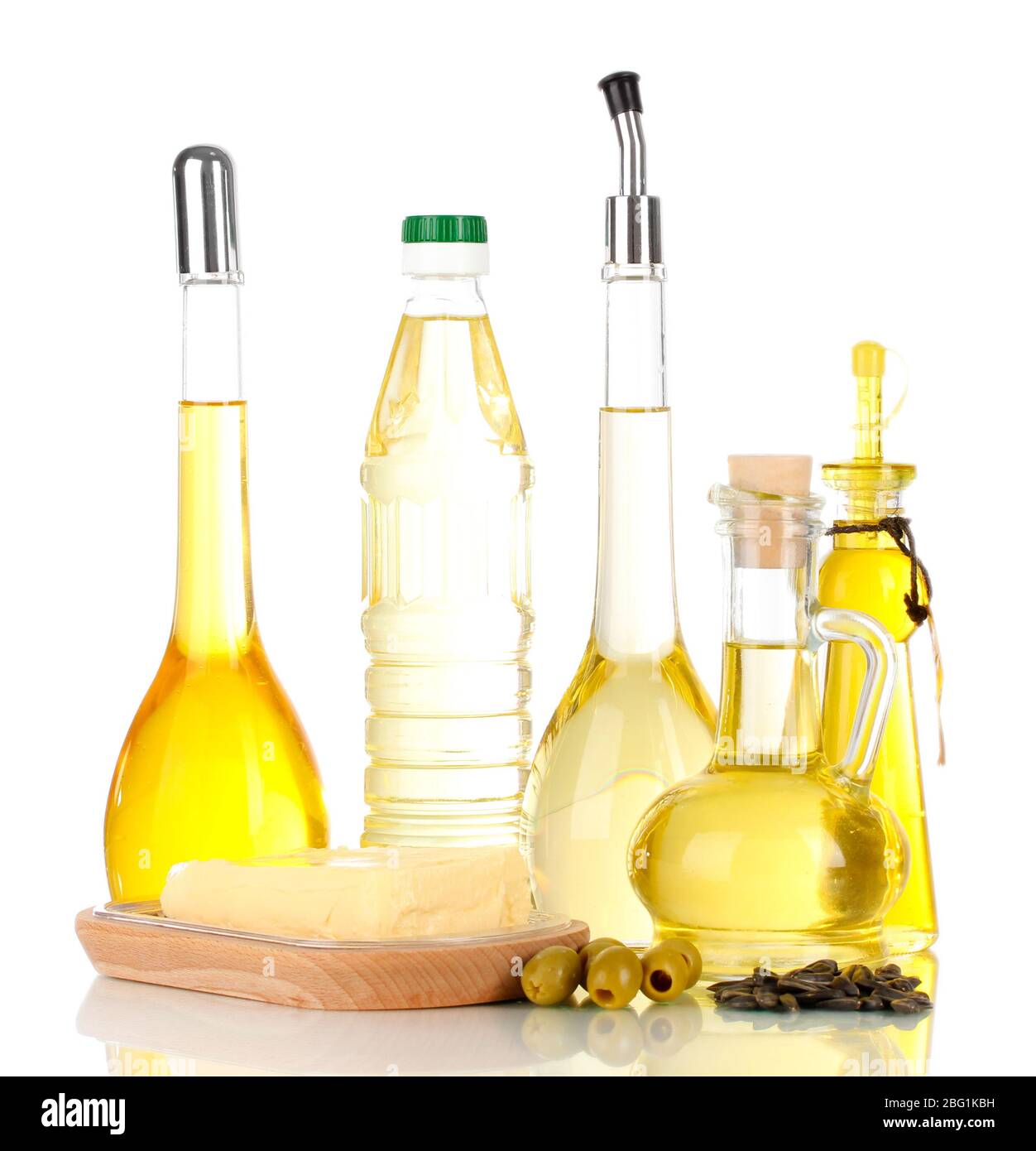 Different types of oil with sunflower seeds and olives isolated on ...