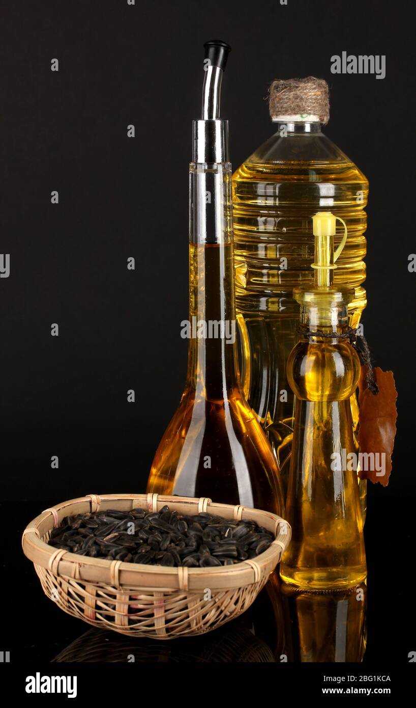 Different types of oil with sunflower seeds on dark background Stock ...