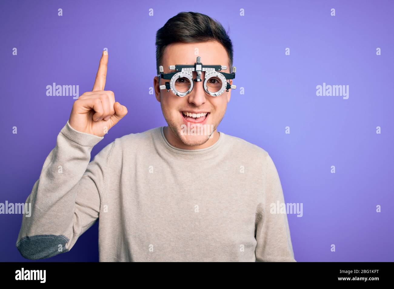 Young handsome caucasian man wearing optometrical glasses over purple ...