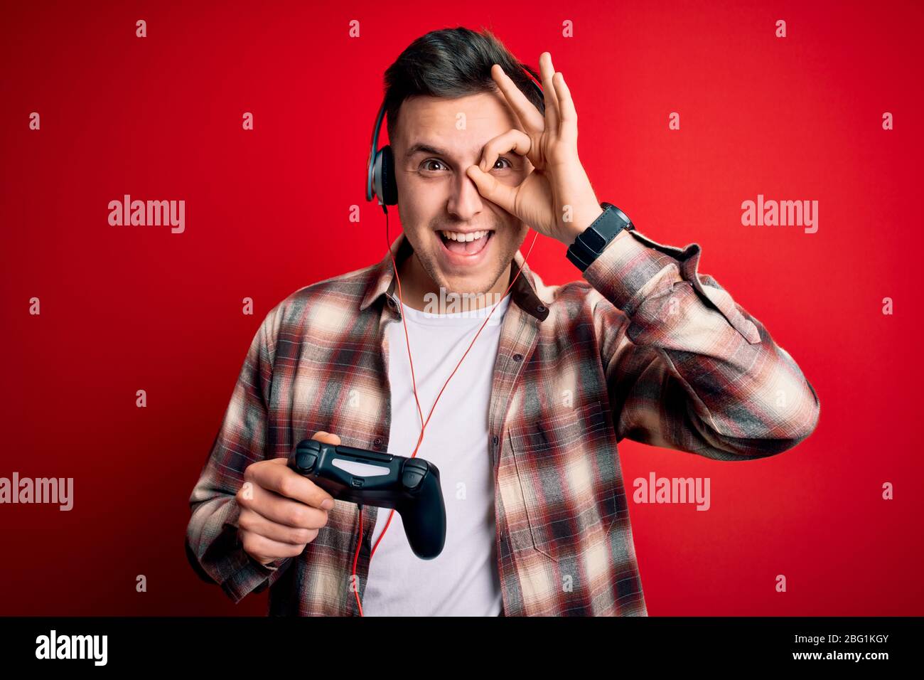 Young handsome caucasian gamer man playing video games using console ...