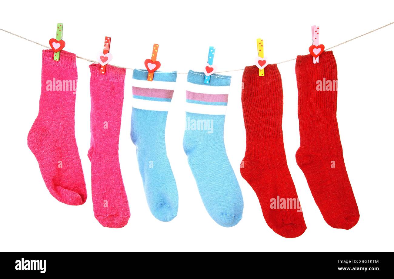 Colorful socks hanging on clothesline, isolated on white Stock Photo ...