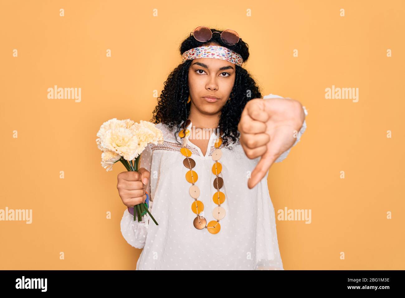 Young african american curly hippie woman wearing sunglasses holding ...