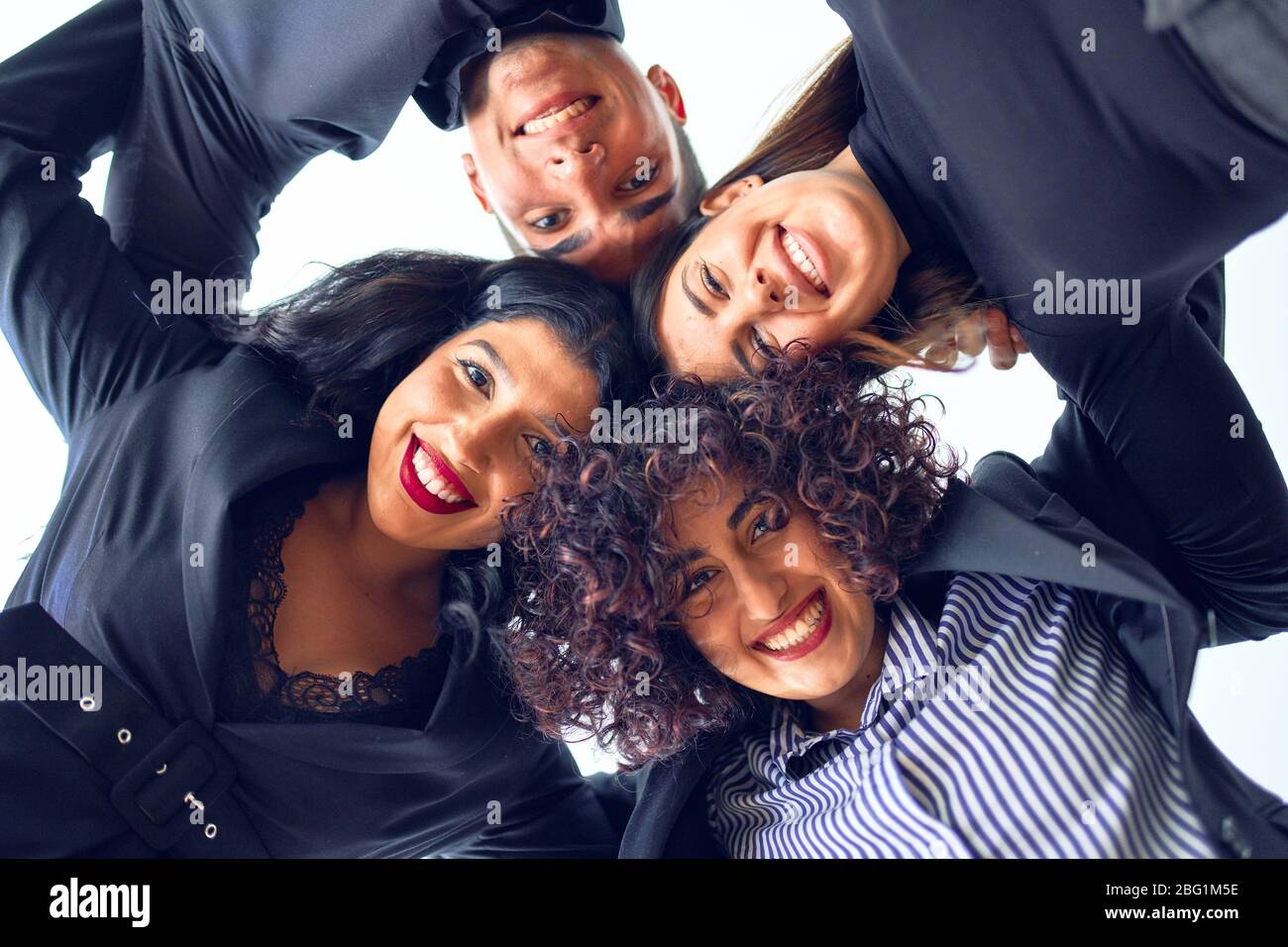 Group of business workers smiling happy. Standing with heads together ...