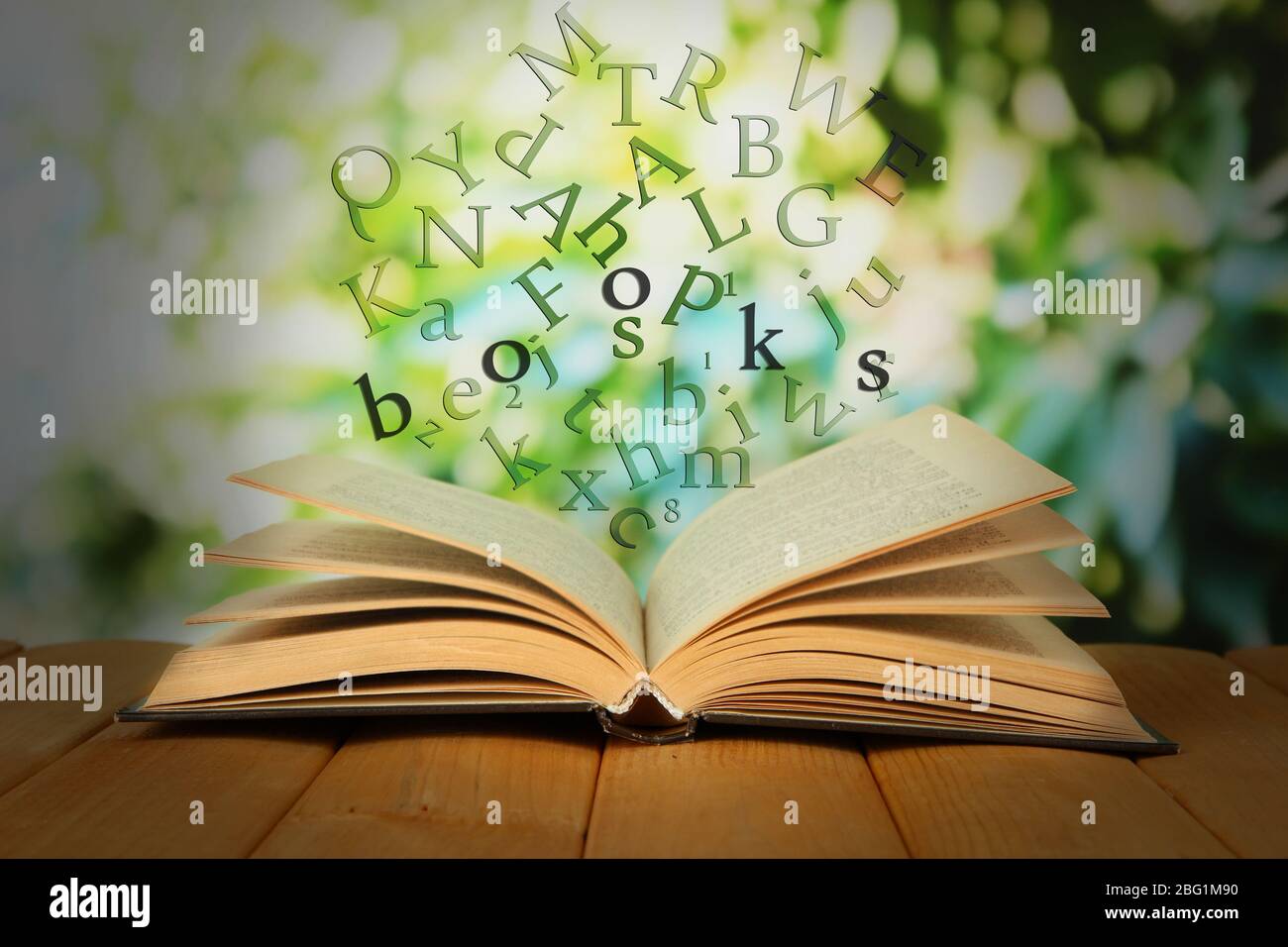 Letters flying out of an open book hi-res stock photography and images - Alamy